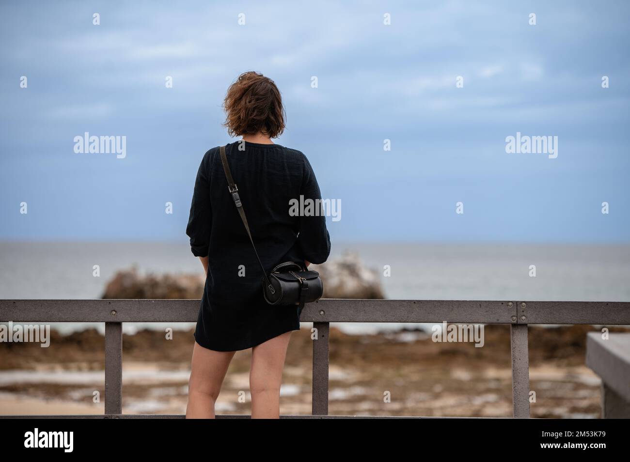 Rear view woman watching ocean hi-res stock photography and images - Alamy