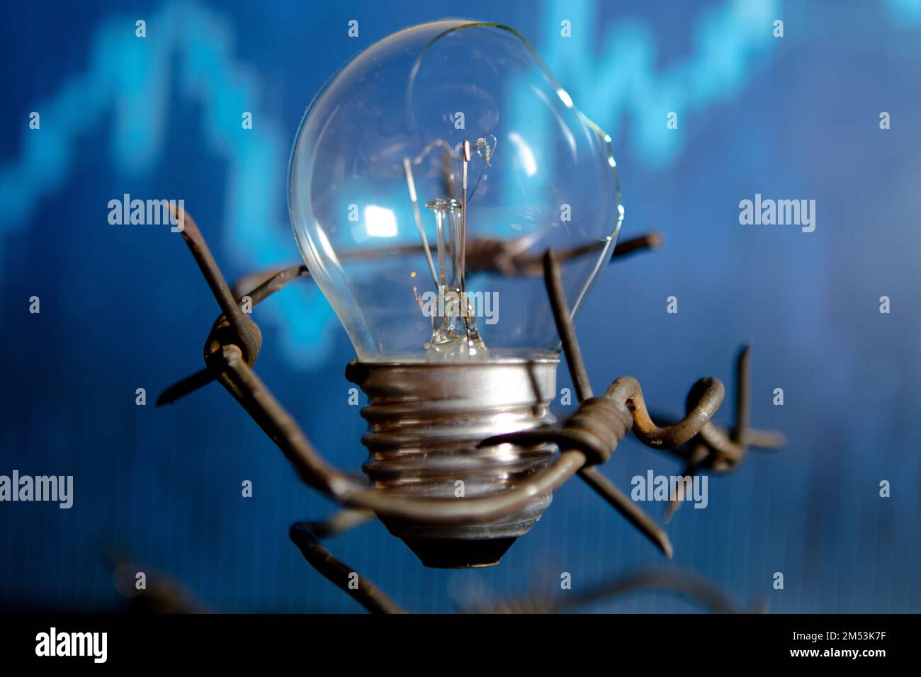 Broken electric light bulb with barbed wire. Concept of electricity ...