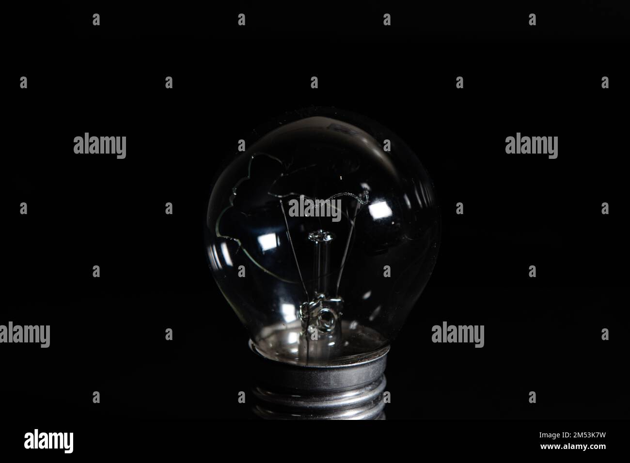 Broken light bulb on black background. Concept of electricity prices ...
