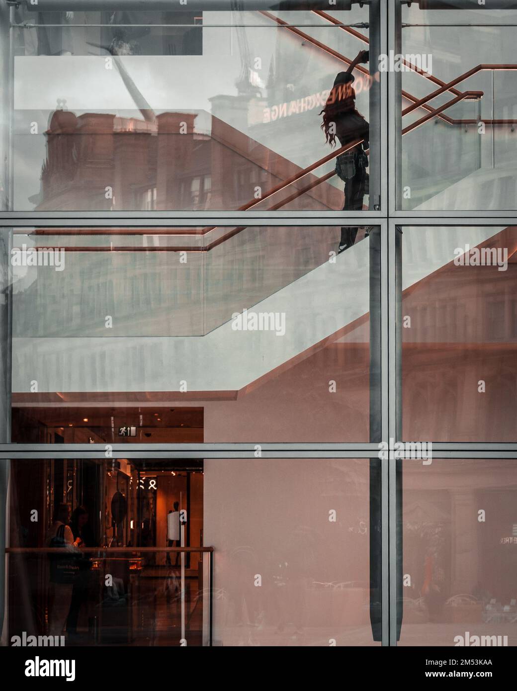 A vertical shot of a female climbing the stairs visible through the ...
