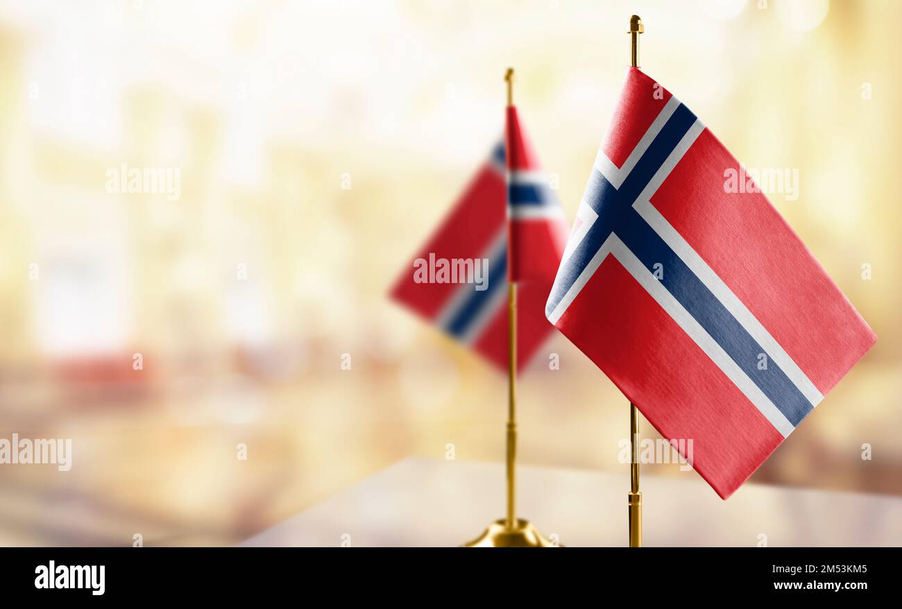 Small flags of the Norway on an abstract blurry background Stock Photo ...
