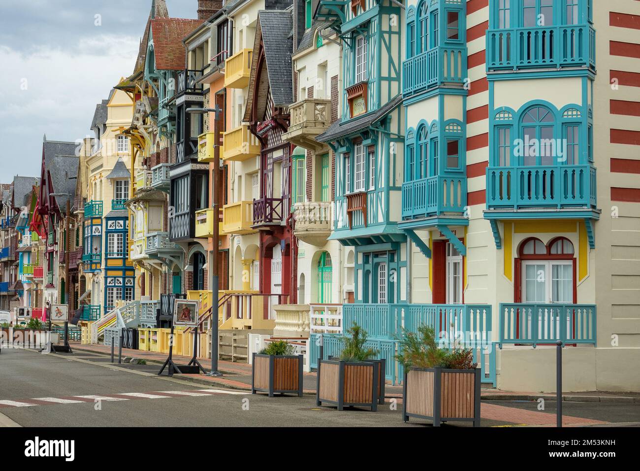A line of colored houses alongside the coastline of Mers-Les-Bains in ...