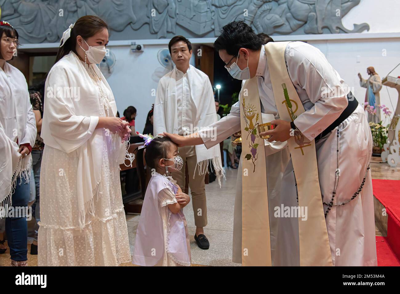 Catholic devotees receive holy communion during the Christmas day mass ...
