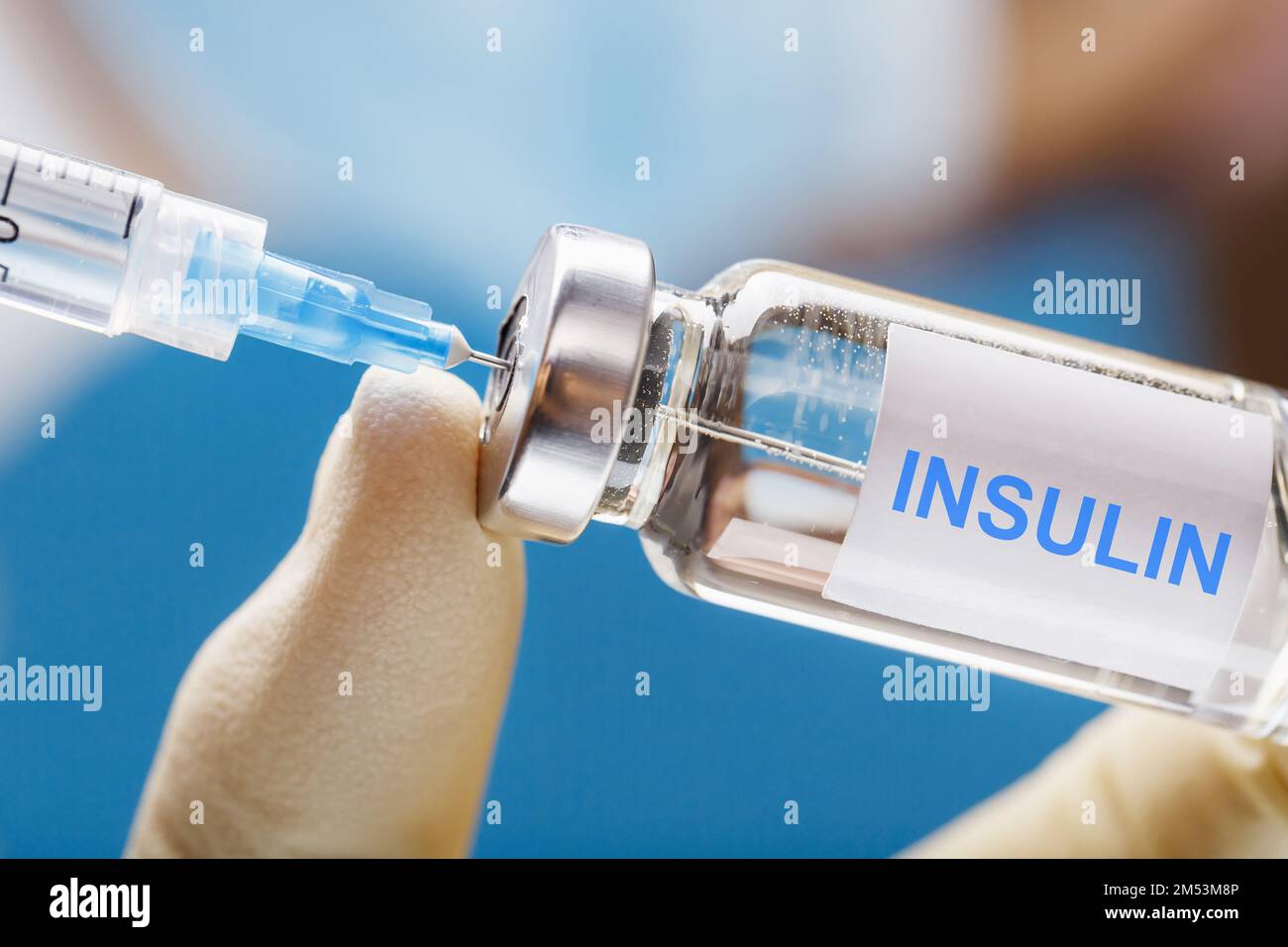 Diabetes treatment a bottle of insulin and a syringe with a needle in ...