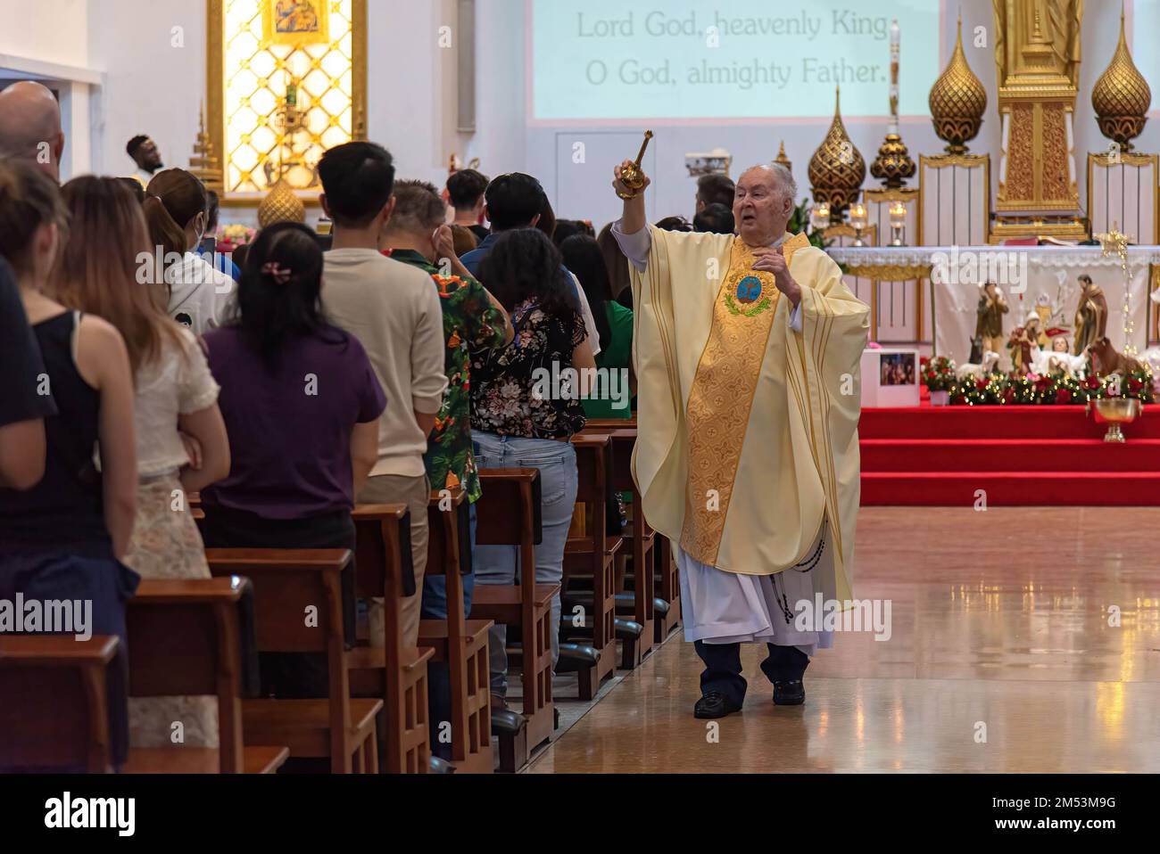 A Catholic priest seen sprinkling a holy water during the Christmas day ...