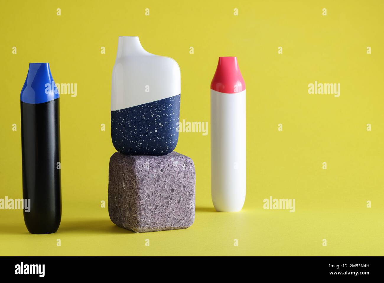 disposable electronic cigarettes or vapes on yellow background. copy ...