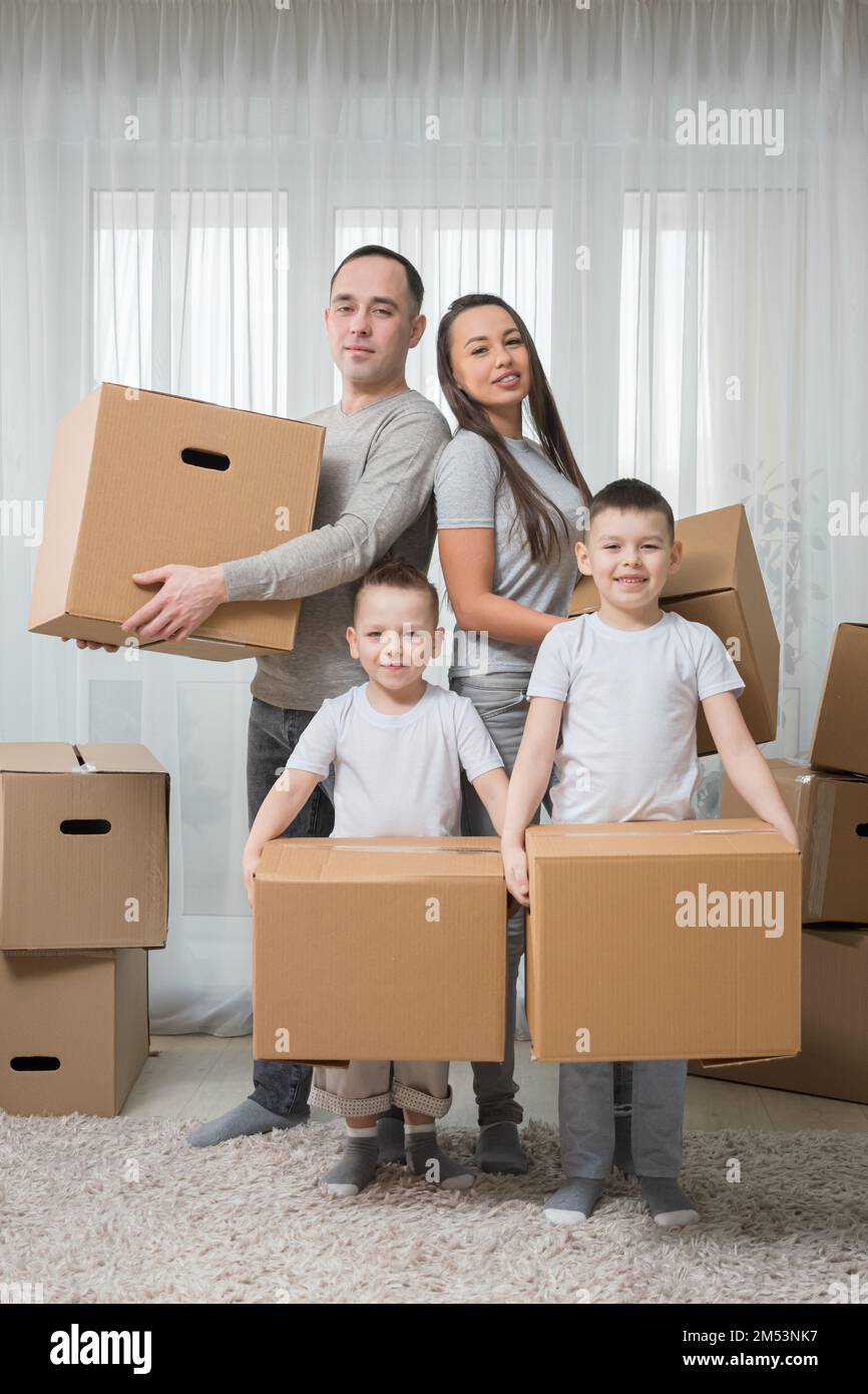Smiling family moving boxes to new house on moving day Stock Photo - Alamy