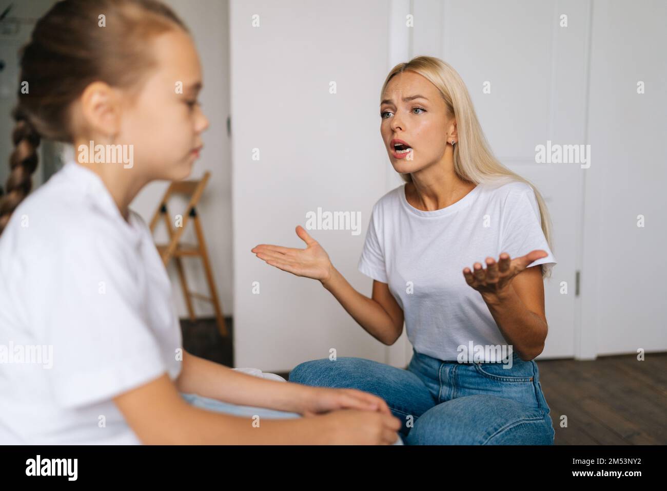 Close-up side view of angry emotional young mother scolding, raising voice, scream and gesturing ...