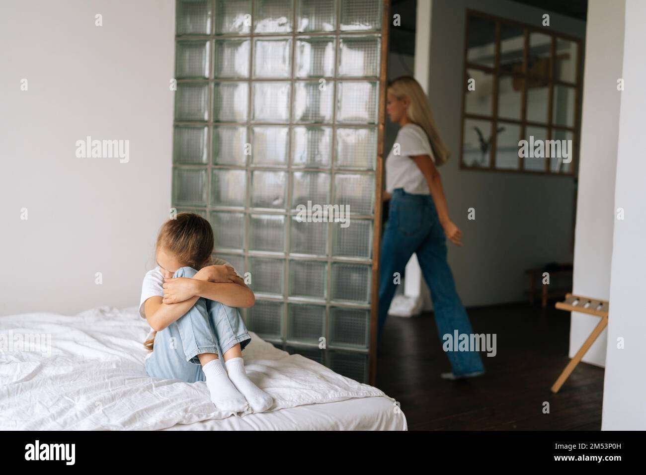 Angry young mother leaving the children room after after quarrel with ...