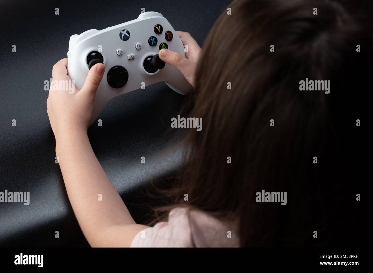 New york, USA - December 21, 2022: Kid hold new xbox x controller on ...