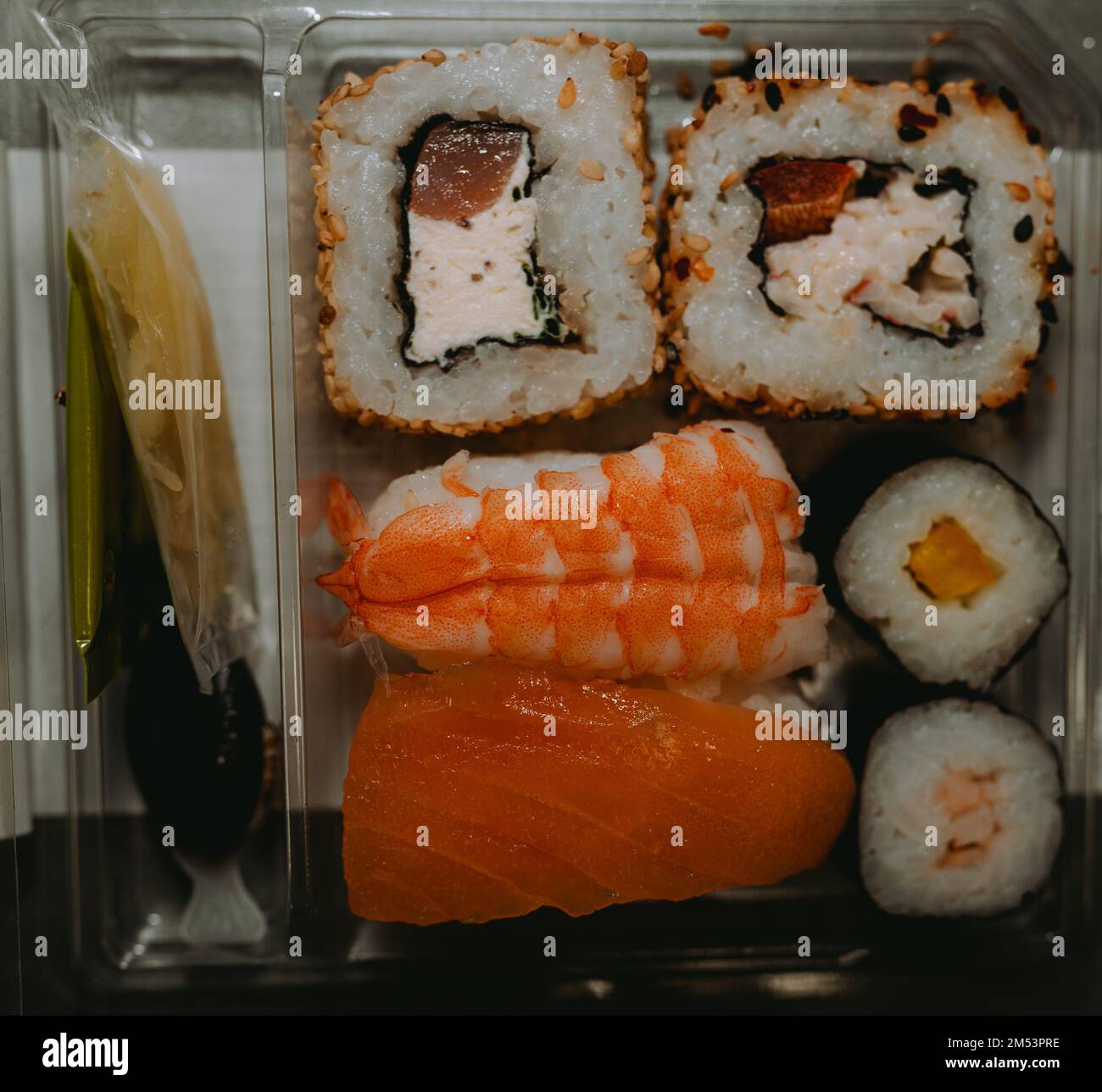 A plastic container with different types of sushi Stock Photo - Alamy