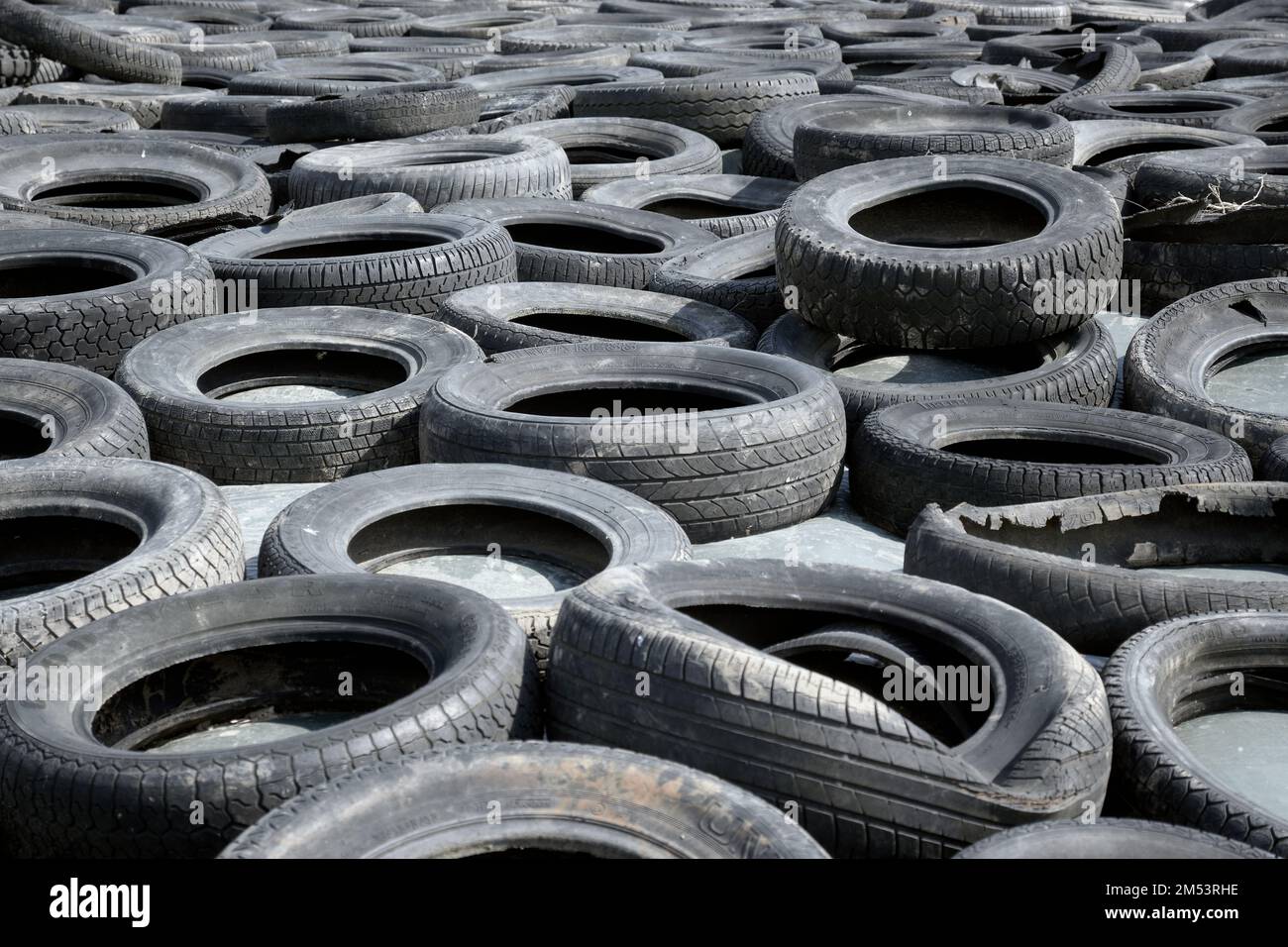 A bunch of old tires laying on the ground Stock Photo - Alamy
