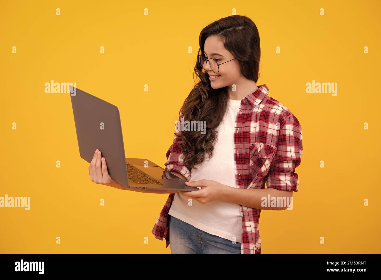 Excited face. Smart little boy with laptop in casual clothes isolated ...
