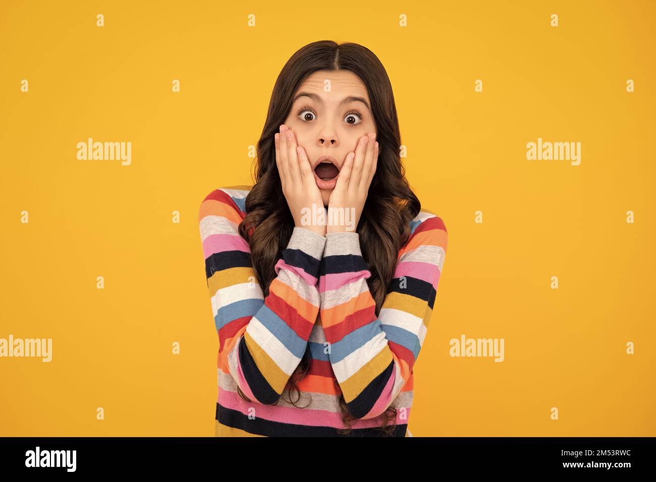 Shocked amazed face, surprised emotions of young teenager girl. Cute young teenager girl against ...