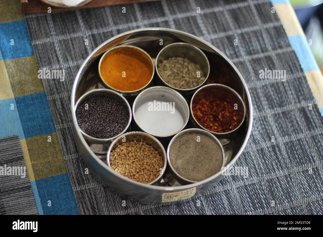A top view of an Indian traditional masala box with various spices ...