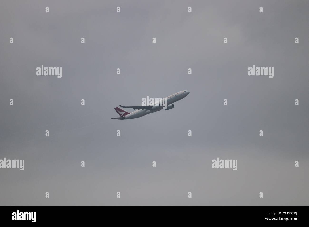A white aircraft flying in the clear white sky Stock Photo - Alamy