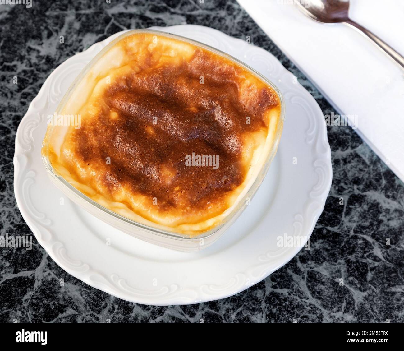 Baked rice pudding Turkish milky dessert sutlac in an earthenware ...
