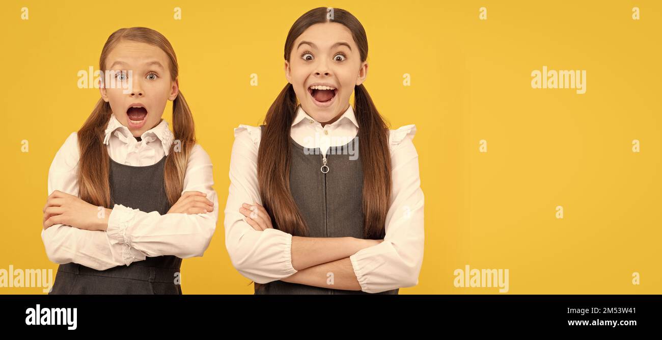 School girls friends. Learn with surprise. Surprised children keep arms ...