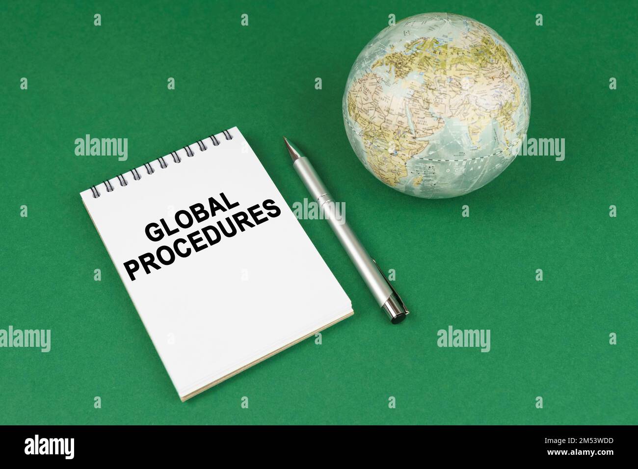 Global concept. On a green surface lies a model of the planet and a ...