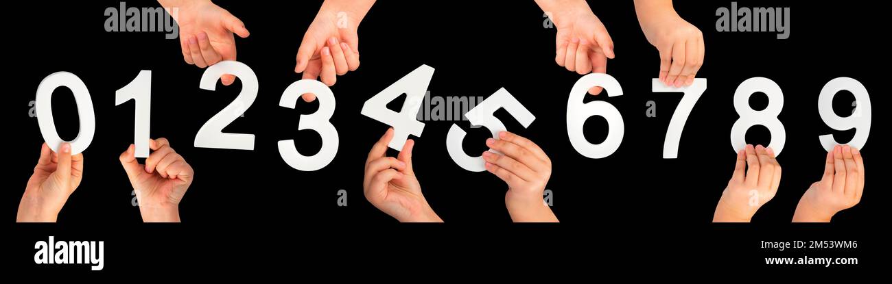 Children's hands hold numbers. A set of white numbers in hands on a ...