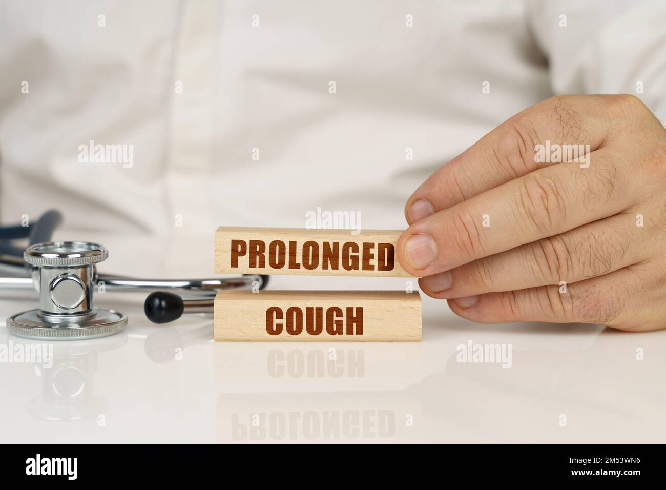 Medical concept. On a white surface, a stethoscope and wooden plates ...