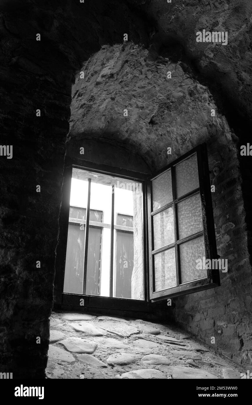 A grayscale shot of a castle window with light shining through Stock ...