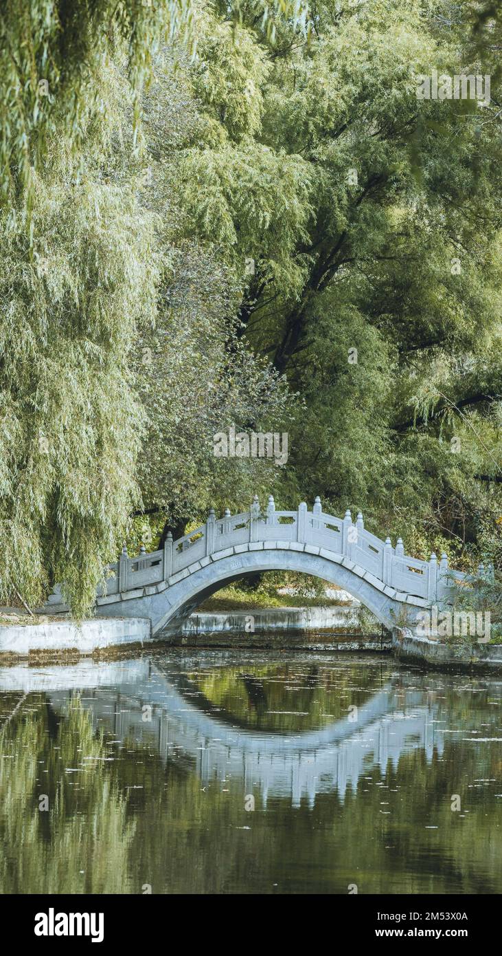 A vertical view of a medieval bridge connecting the riverbanks in a ...
