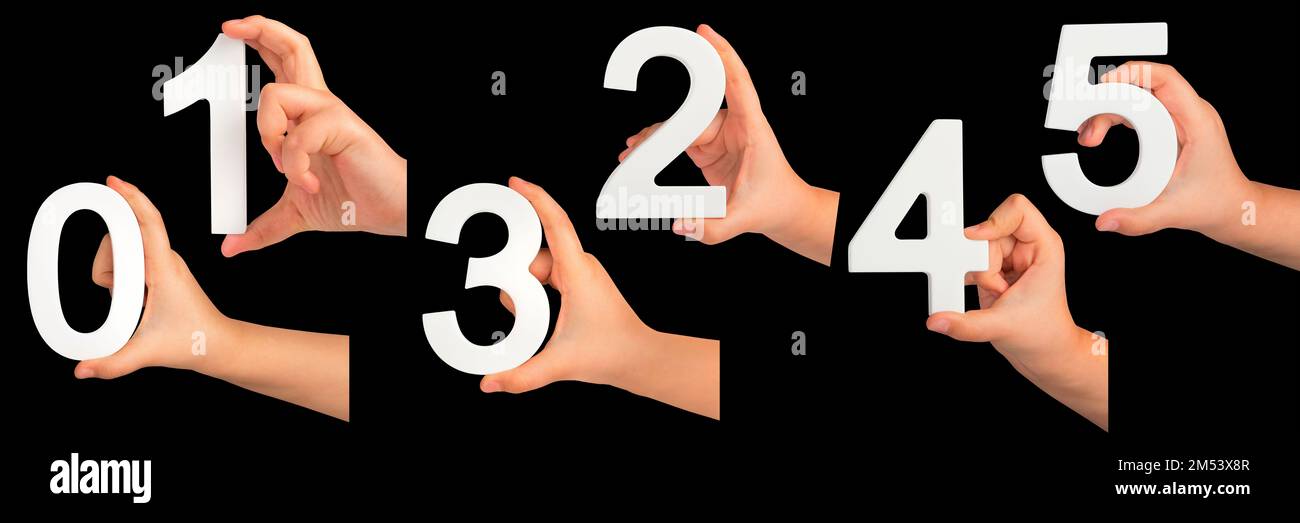 Children's hands hold numbers. A set of white numbers in hands on a ...