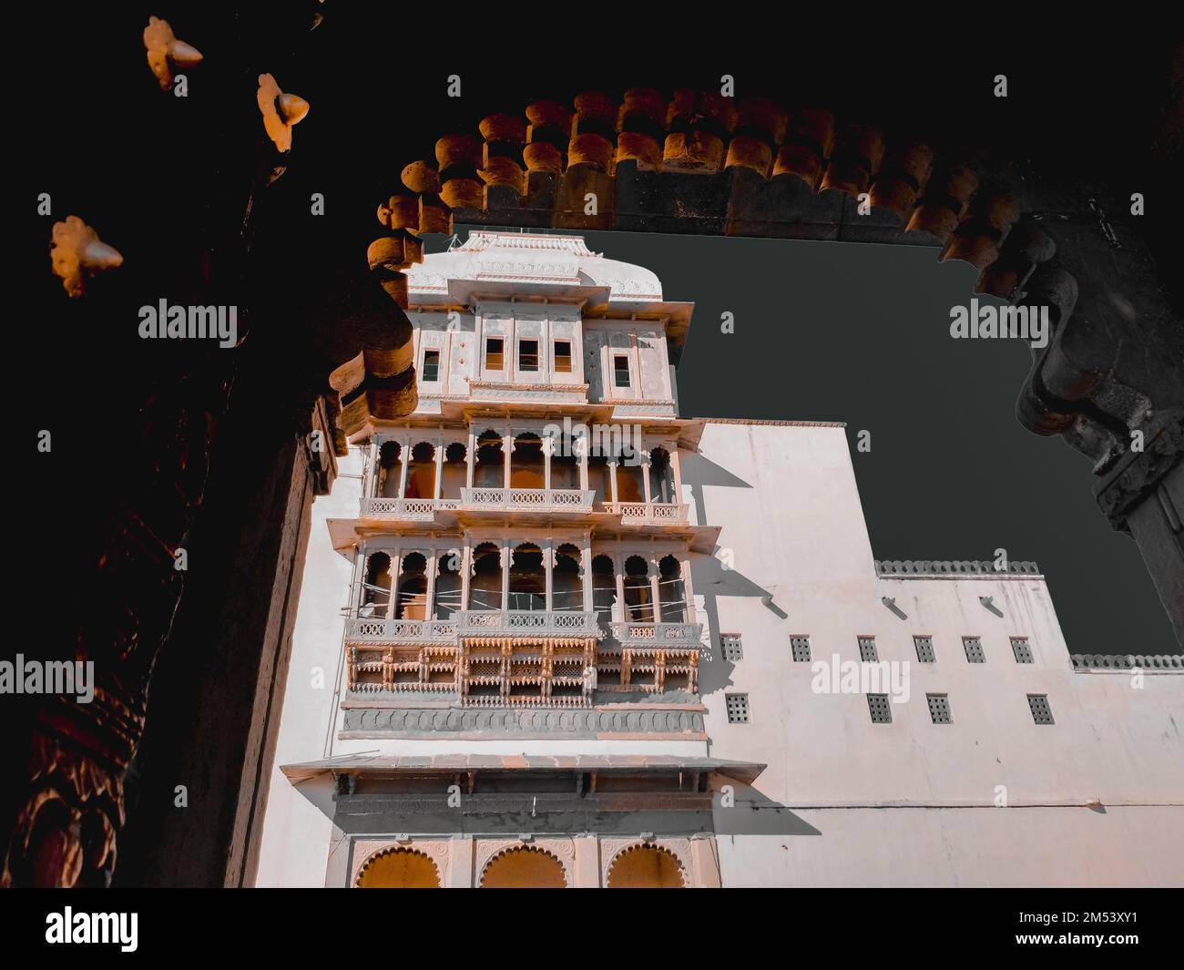 A low-angle shot of the front gate and Sajjangarh Monsoon Palace ...