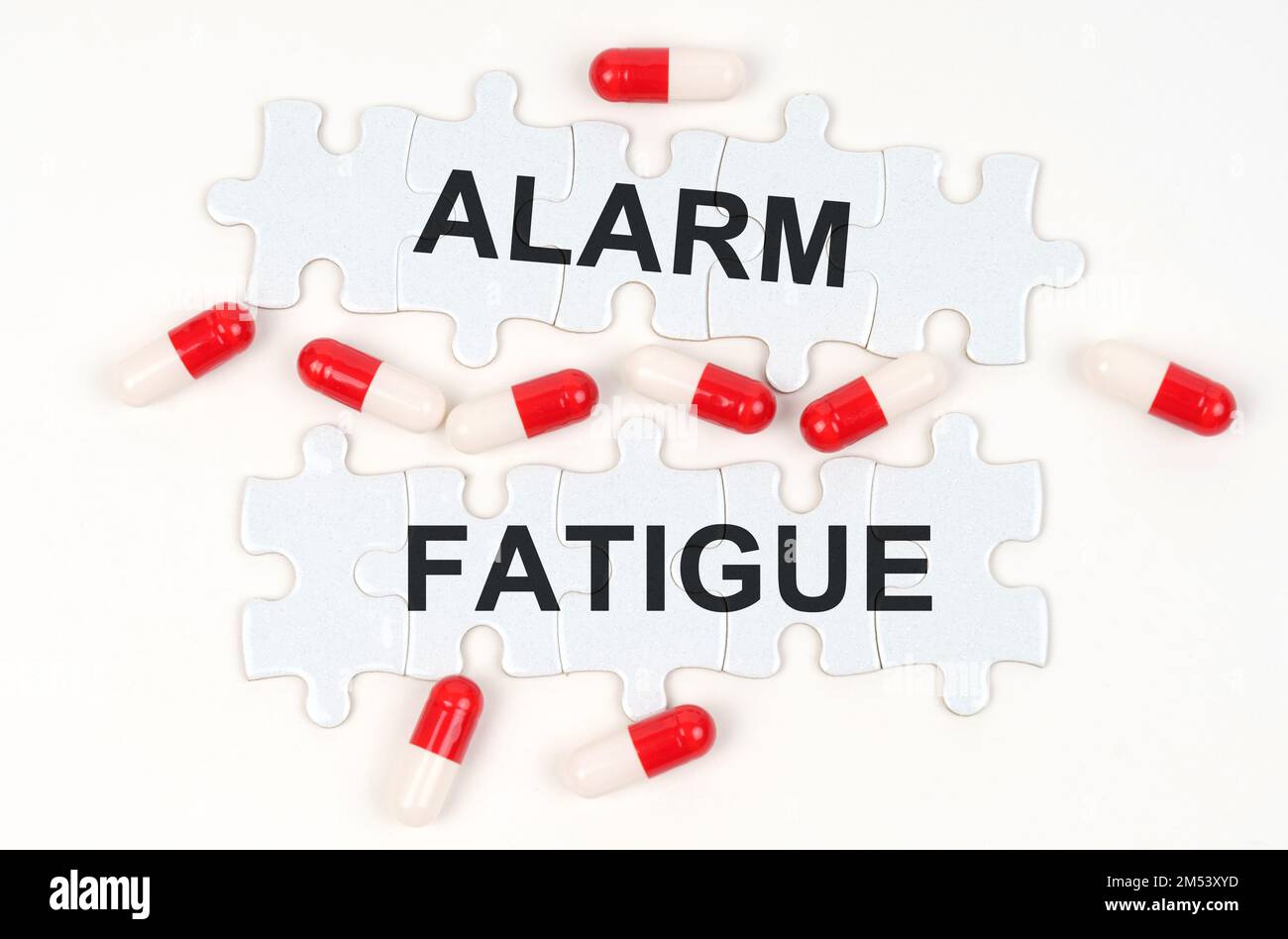 Medical concept. On a white surface, tablets and puzzles with the ...