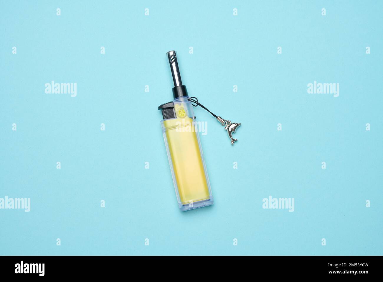 Yellow plastic lighter on a blue background, top view Stock Photo - Alamy