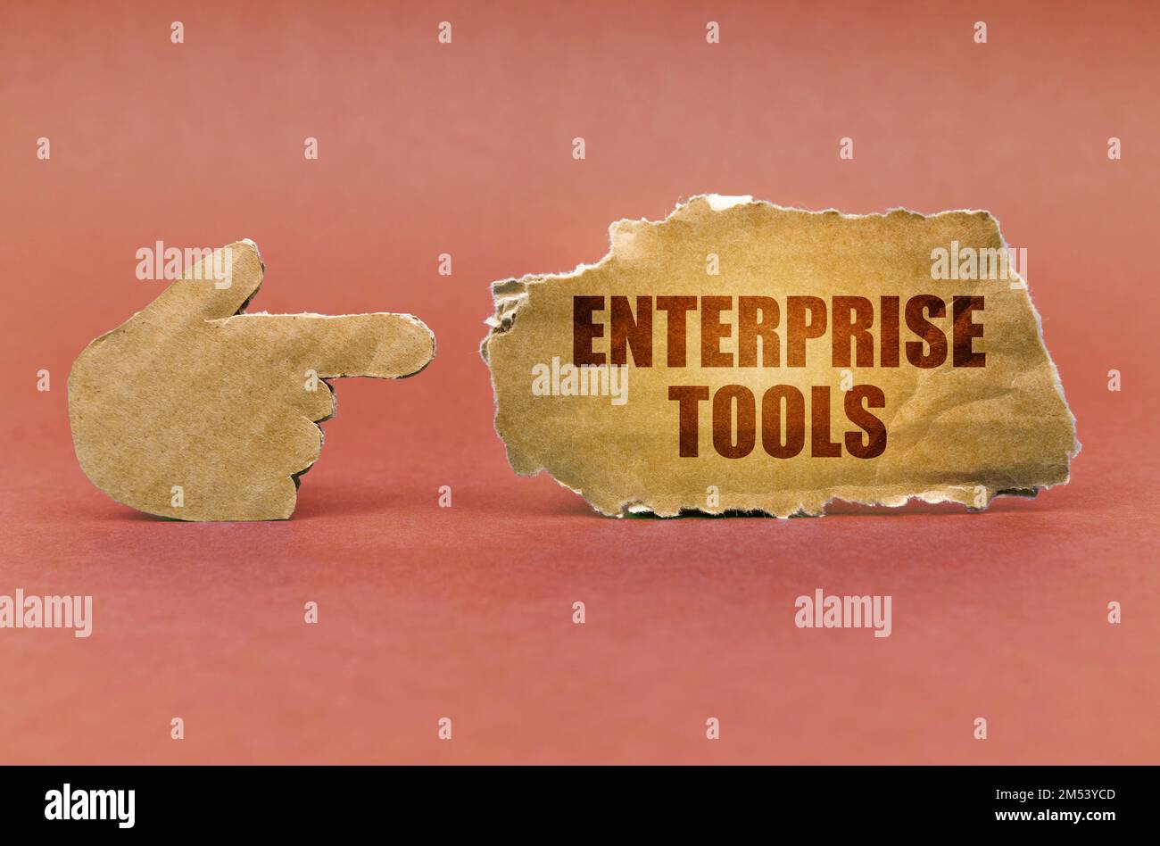 Business and technology concept. On a brown surface, a cardboard hand ...