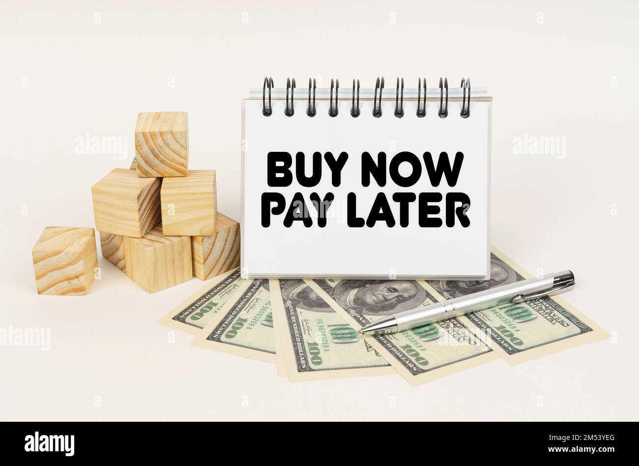 Business concept. On a white surface, cubes, dollars, a pen and a ...