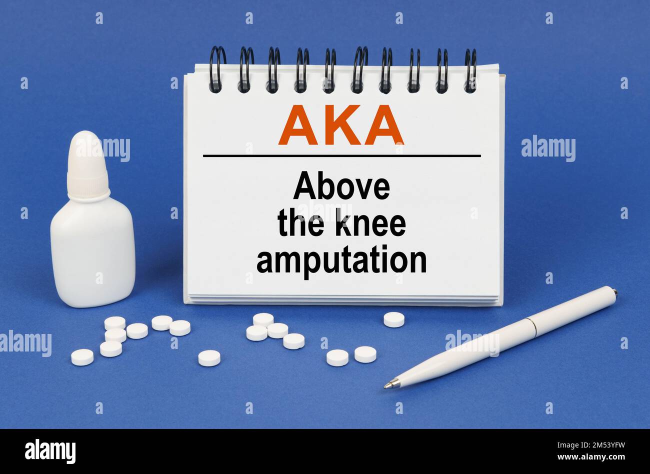 Medical concept. On a blue background, a pen, tablets and a notepad ...