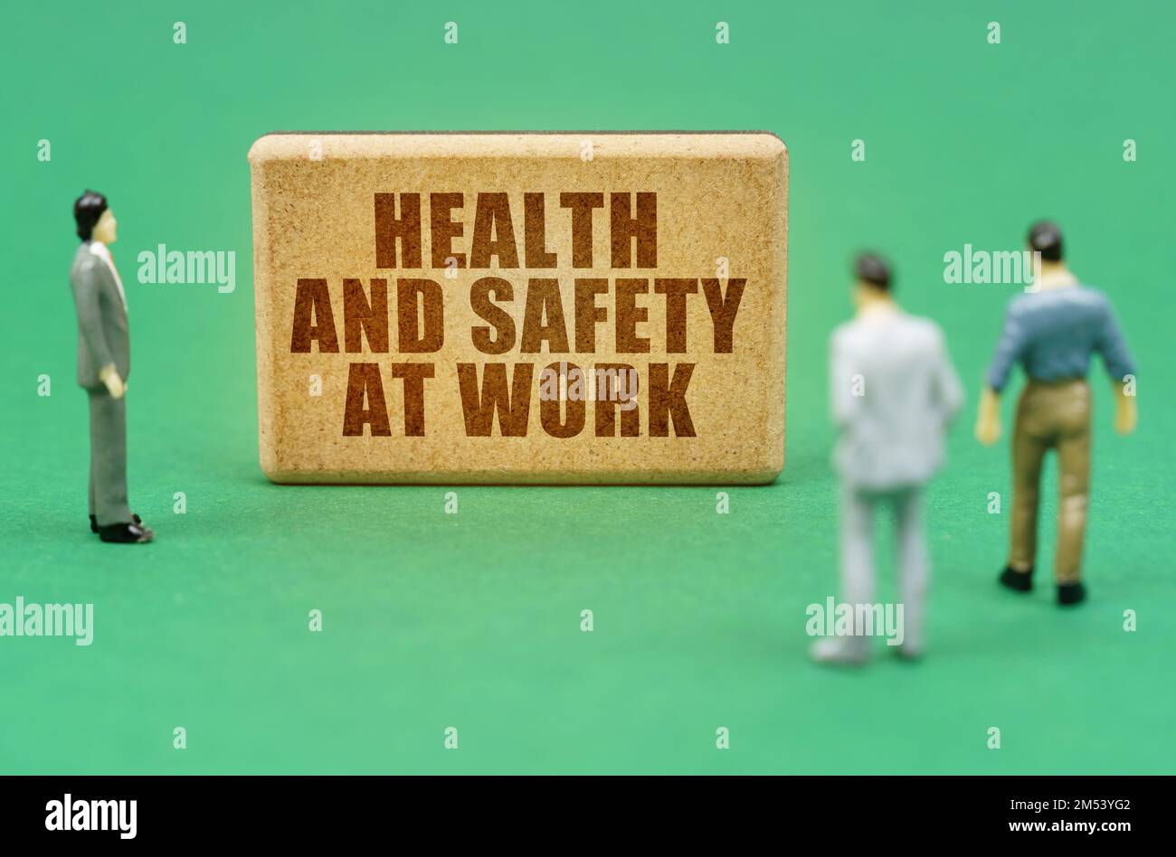 Security and insurance concept. On the green surface are figures of ...