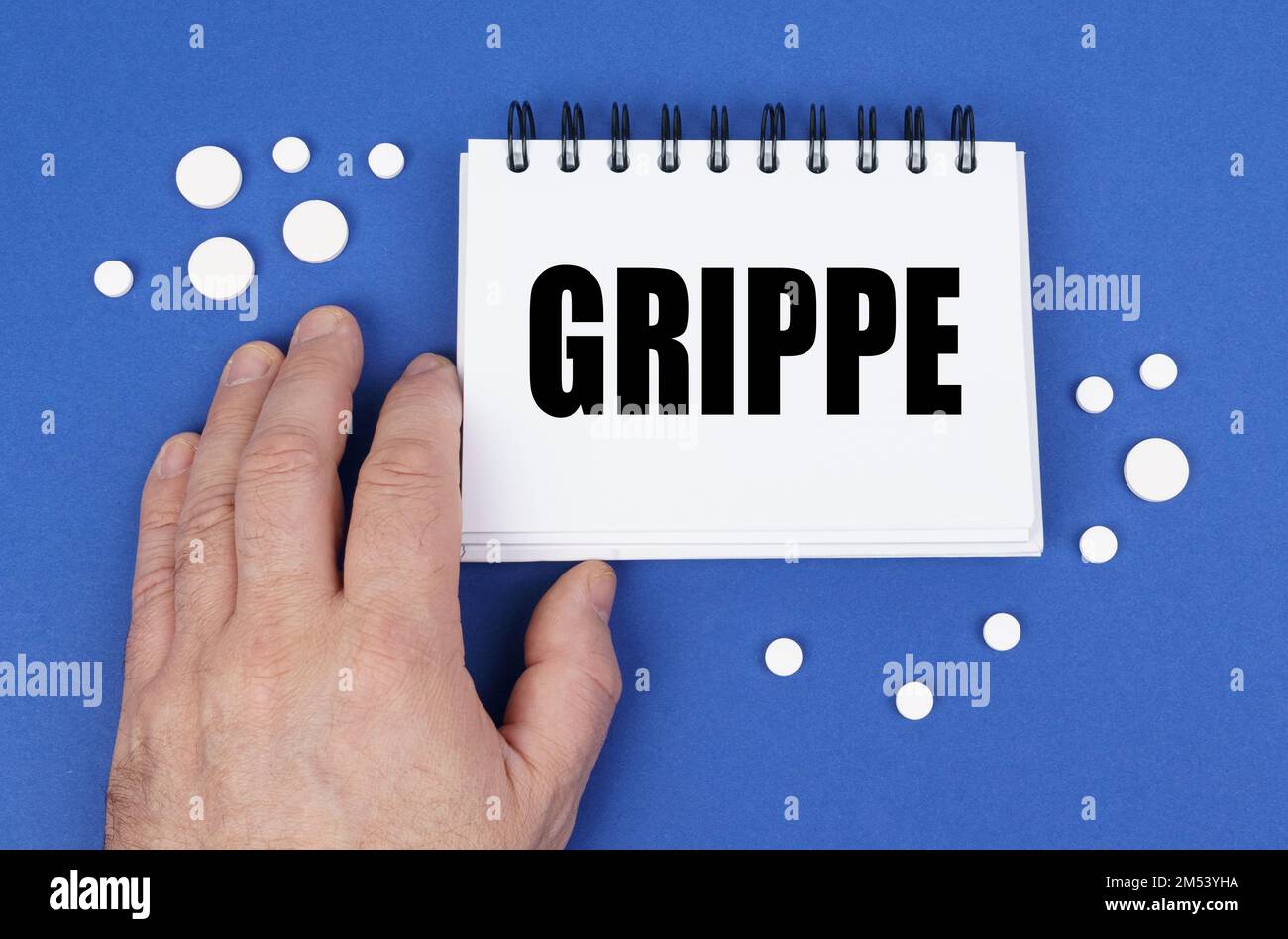 Medical concept. On the blue surface of the tablet, a hand and a ...