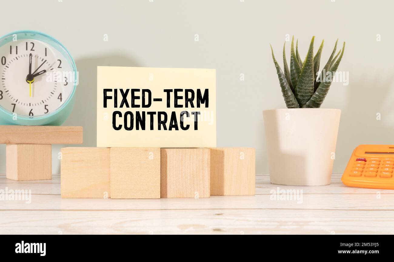 Top view clock and miniature people with text Fixed-Term Contract on a ...