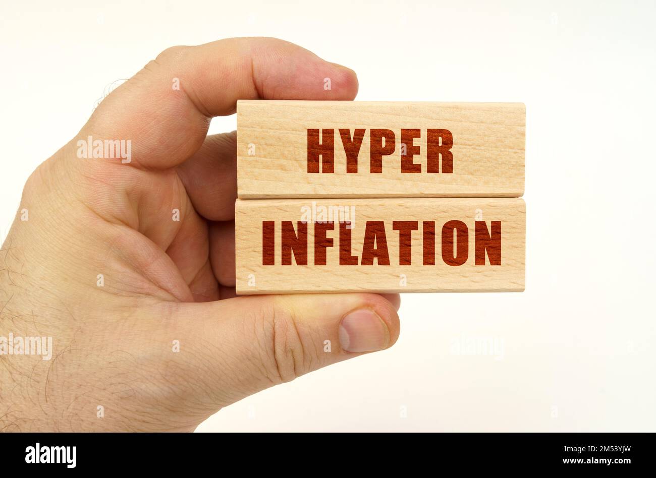 Business concept. On a white background, a hand that holds wooden ...