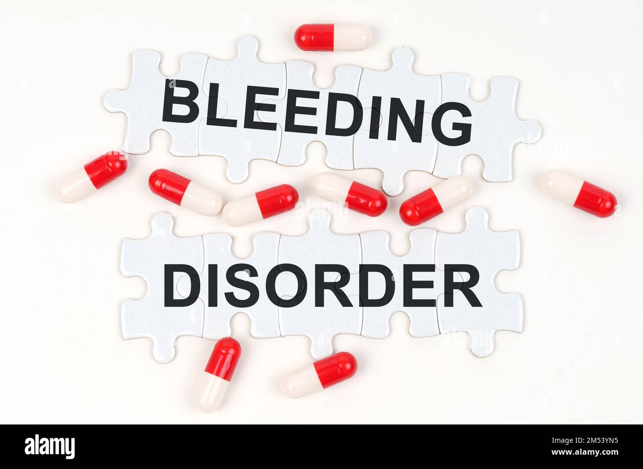 Medical concept. On a white surface, tablets and puzzles with the ...