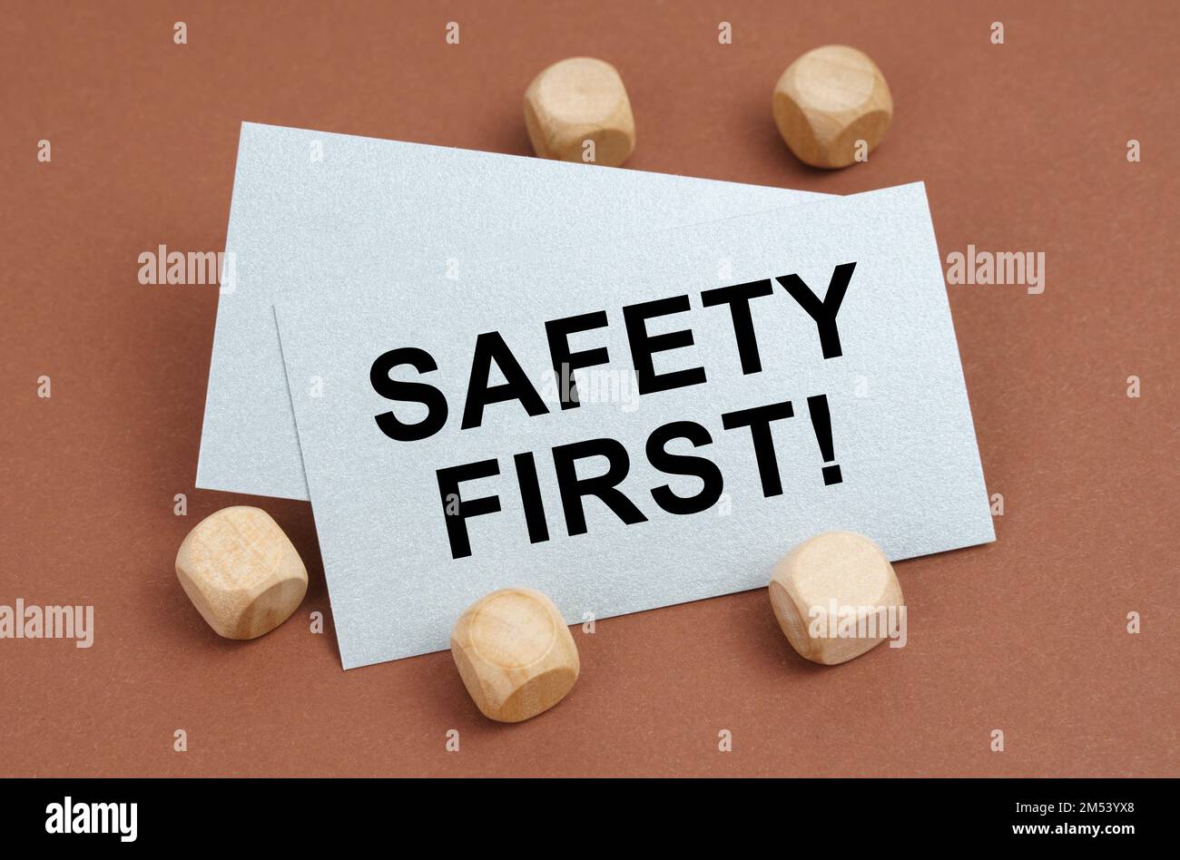 The concept of industrial safety. On a brown surface, wooden cubes and ...