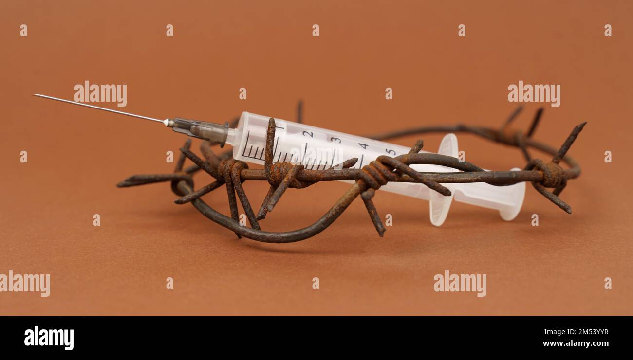 The concept of justice and law. On the brown surface is a drug syringe ...