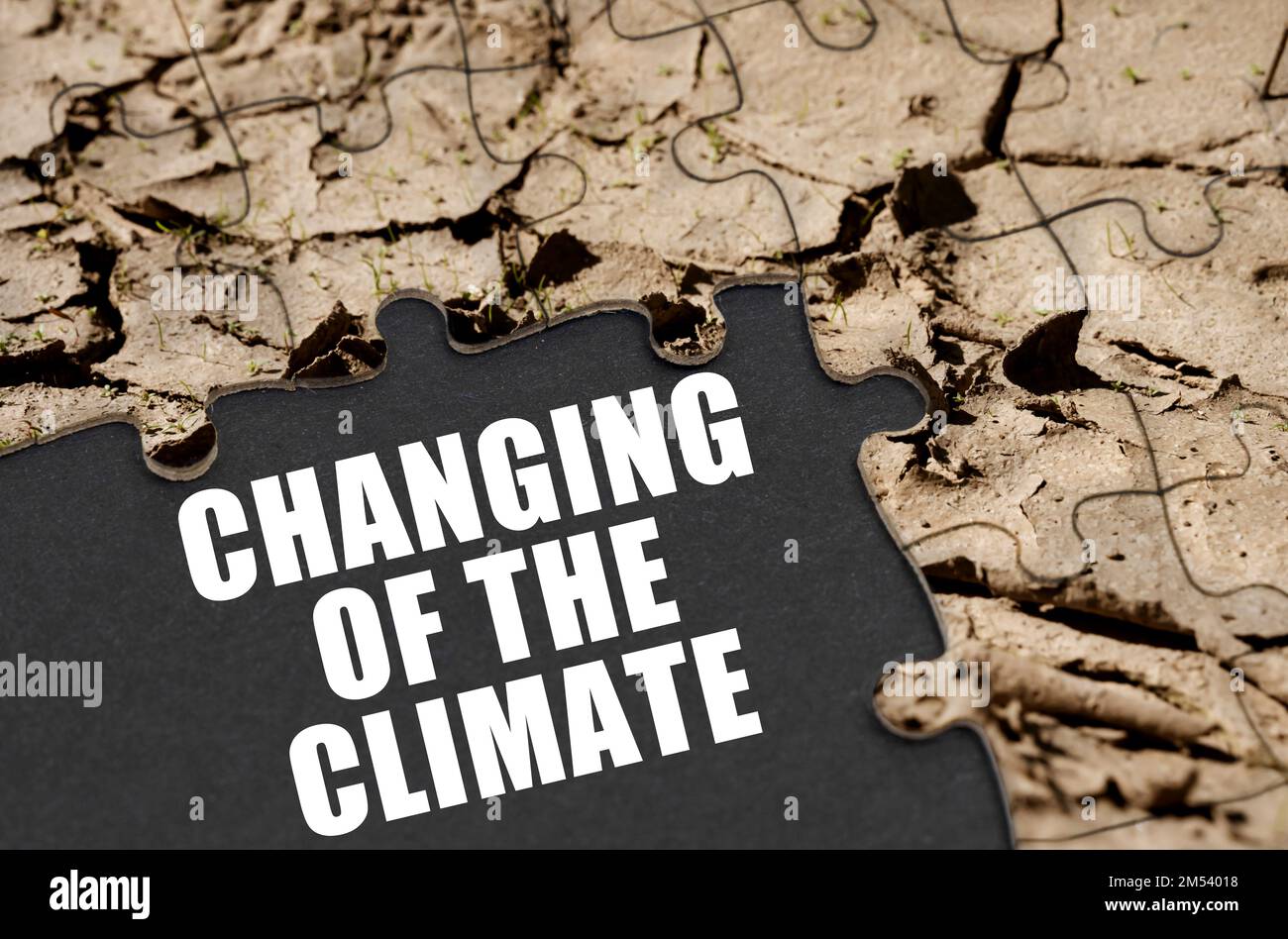 Ecological concept. The puzzles depict soil, next to a black surface ...