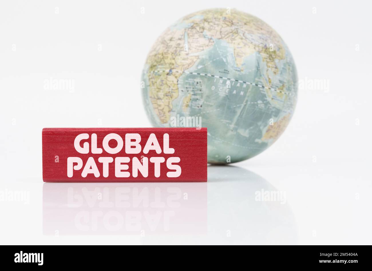 Industrial and business concept. Near the globe is a red plaque with ...