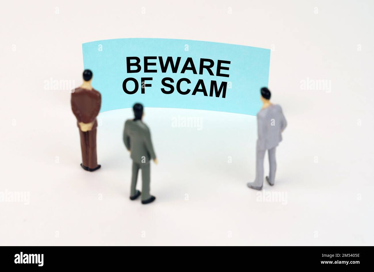 Medical concept. Miniature figures of people stand in front of a blue ...