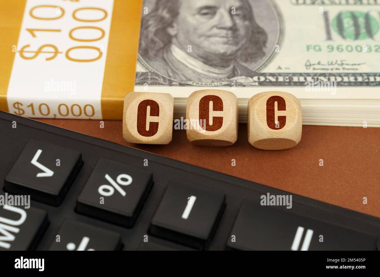 Business concept. On the table are dollars, a calculator and cubes with the inscription - CCC ...