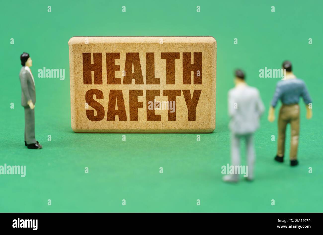 Security and insurance concept. On the green surface are figures of ...