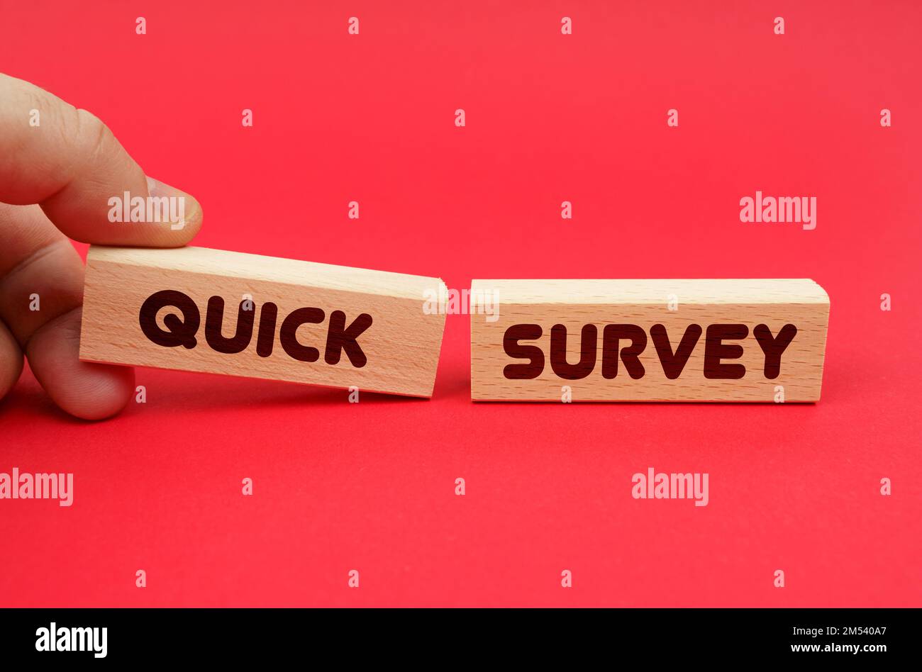 Business concept. On a red background, wooden blocks, one of them in ...
