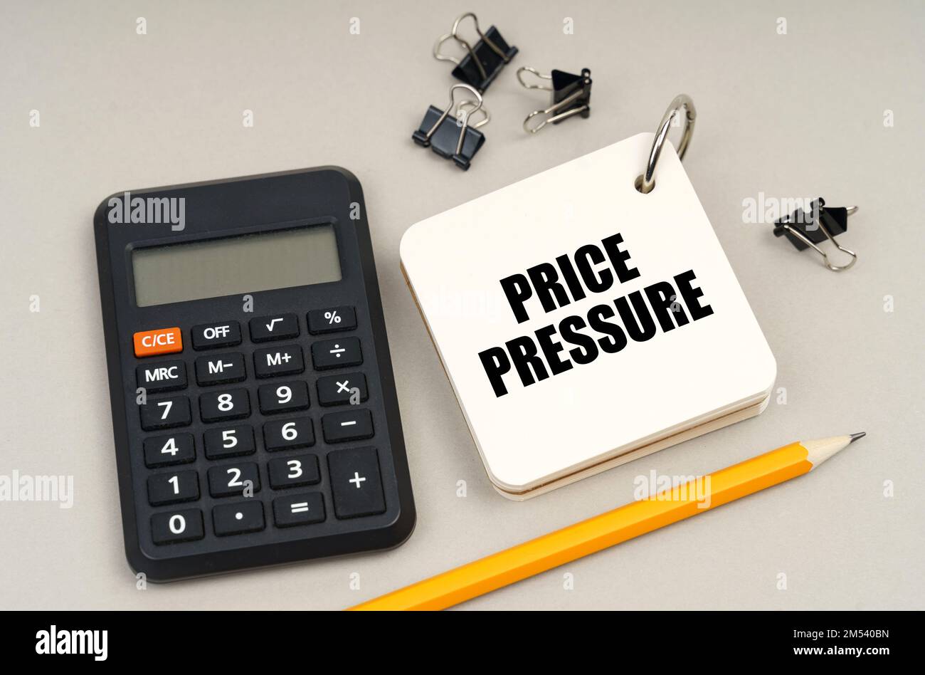 Business concept. On a gray surface, a calculator, a pencil and a ...