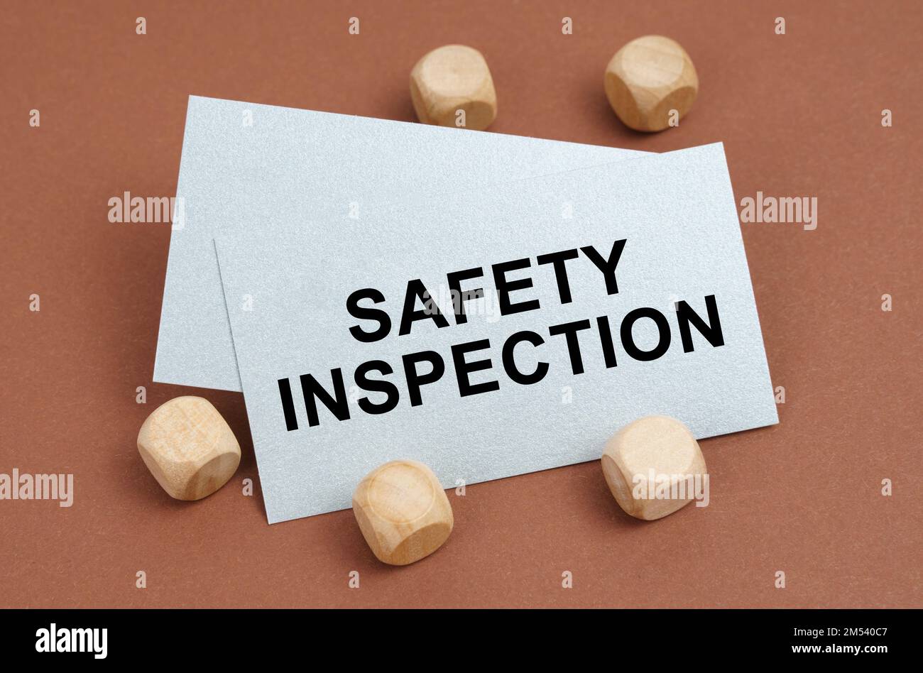 The concept of industrial safety. On a brown surface, wooden cubes and ...