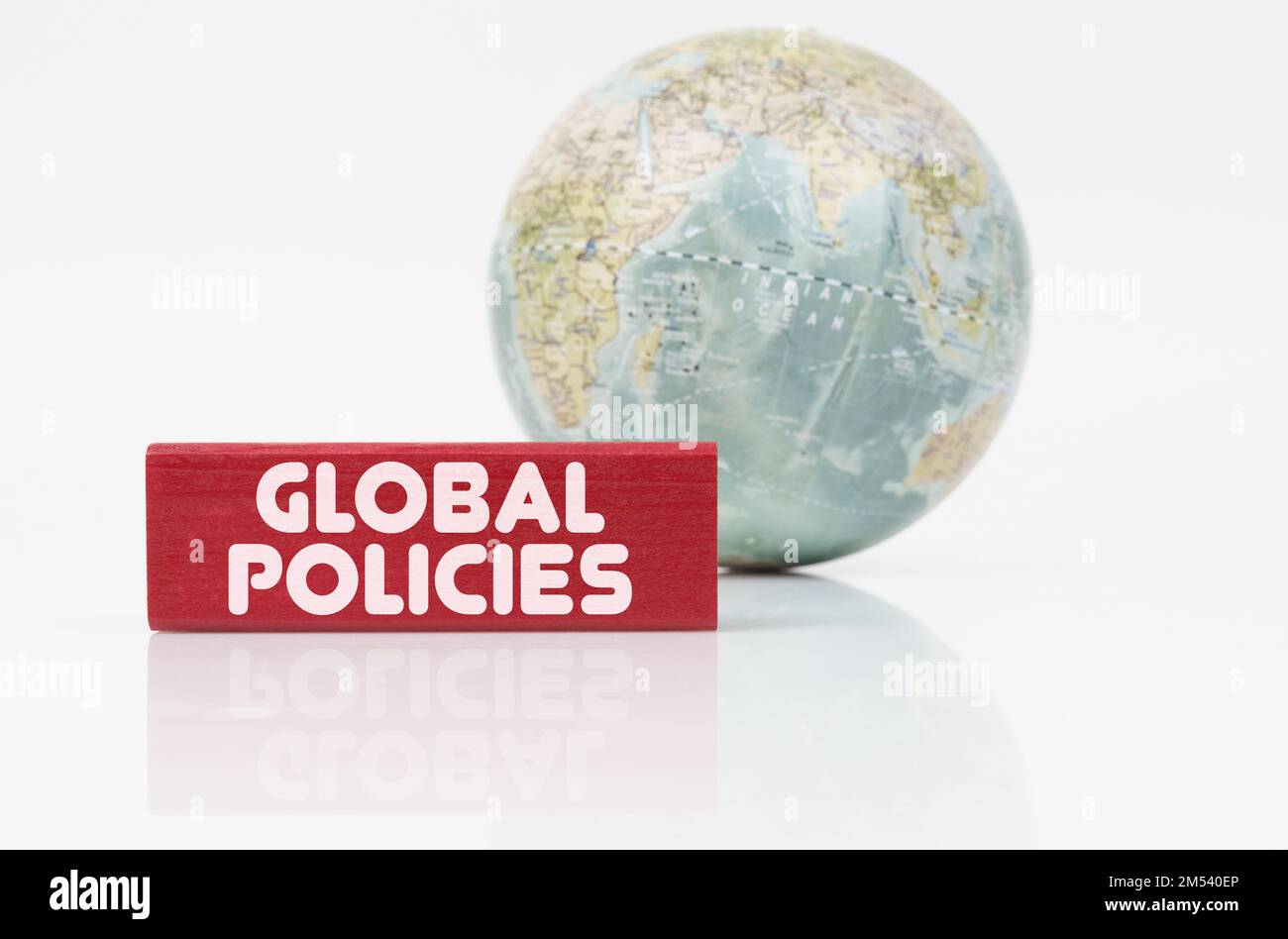 Business and technology concept. Near the globe is a red plaque with ...